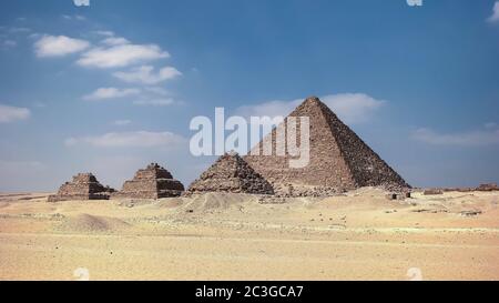 A scenic shot of the Giza pyramid complex against the blue sky in Egypt ...
