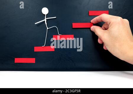 Ladder to success concept. Human stick figure taking first step on a ...