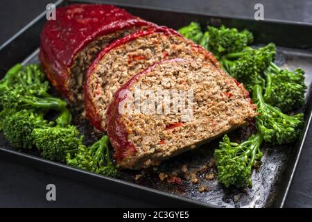 Traditional American meatloaf with ketchup on wooden table Stock Photo ...