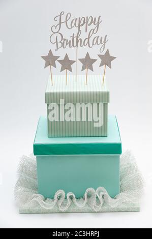 Birthday cake made of beautiful gift boxes on color background Stock ...