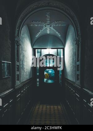 A vertical shot of a corridor inside an ancient building with arches ...