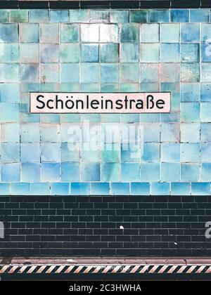 A vertical shot of a sign with German writing and bubbles in nature ...