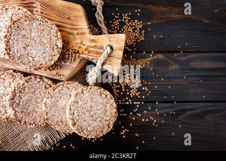 Airy, round, crisp buckwheat crispbread on wooden background with ...