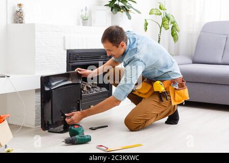 Tv repairman technician repairing tv at home Stock Photo - Alamy
