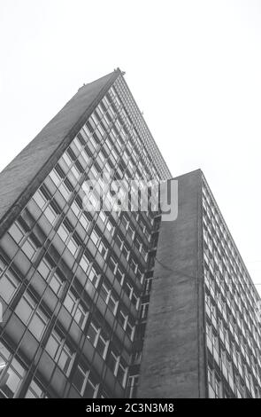 Monochromatic exterior of an apartment building with windows forming a ...