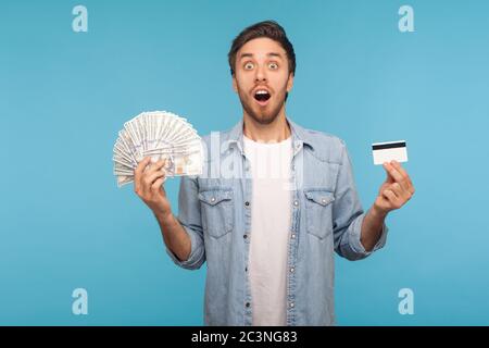 amazed man with business debit in studio. man holding business debit ...