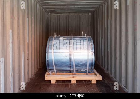 Steel coils on wooden pallets in warehouse stuffing area for container ...