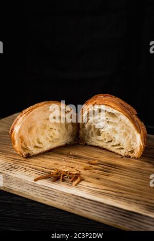 Cut in half croissant with inside texture and thin crisp layers on ...