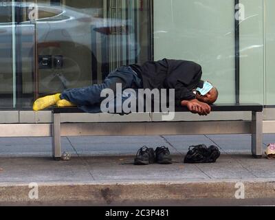 Homeless man sleeping in a bus shelter in Skokie, Illinois Stock Photo ...