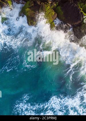 Vertical overhead shot of the wavy sand with the sun shining on it ...