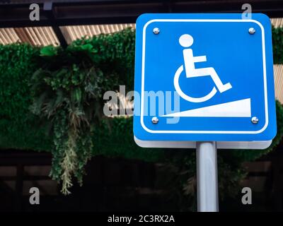 Closeup of Blue Badge wheelchair symbol and disabled parking signage in ...