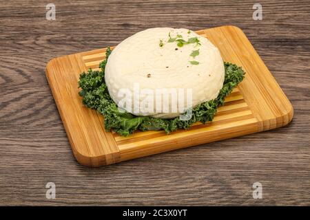 Caucasian suluguni round dairy cheese piece Stock Photo - Alamy