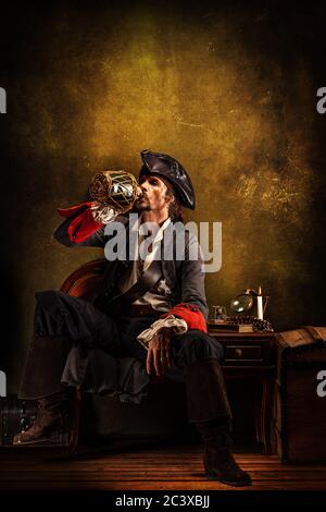 Portrait of a pirate drinking rum, sitting in a tavern Stock Photo - Alamy