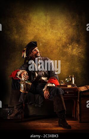 Portrait of a pirate drinking rum, sitting in a tavern Stock Photo - Alamy