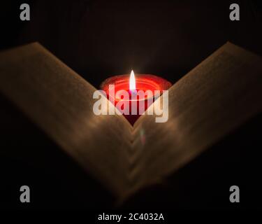 Reading a book by candlelight Stock Photo - Alamy