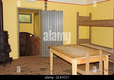 living quarters; German bunker interior; yellow walls, wood bunk beds ...