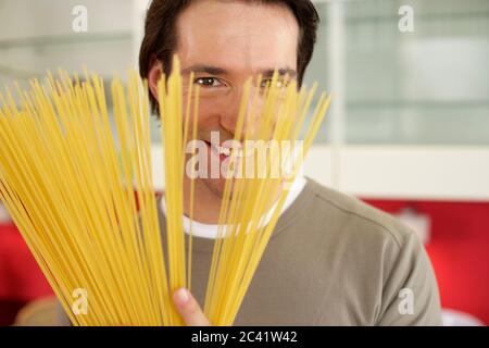 Man holds spagetti in his hands Stock Photo - Alamy