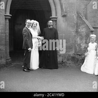 1960s, historical, wedding, outside the church, a bride and groom ...