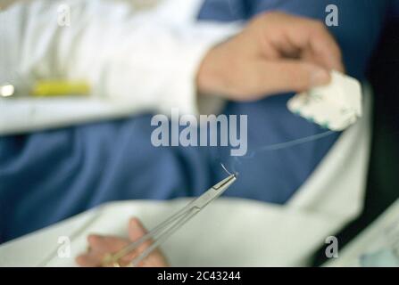 Doctor with surgical sewing kit (detail) - hospital Stock Photo - Alamy