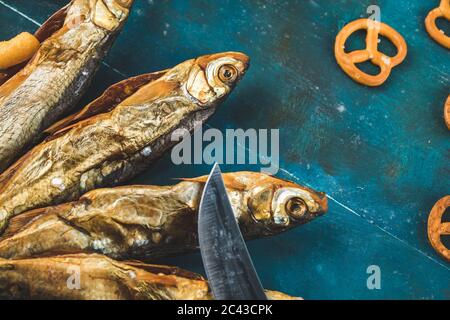 Crackers with smoked fish on the blue table Stock Photo - Alamy