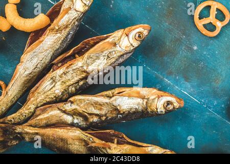 Dry fish and crackers on the blue table with cheese and olives Stock ...
