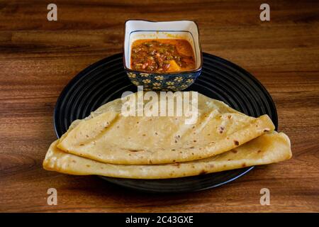 Chapati with chicken curry mix with sardine sambal Stock Photo - Alamy