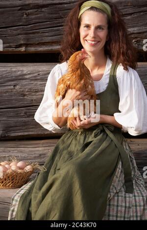 Woman with chicken in her arms Stock Photo - Alamy