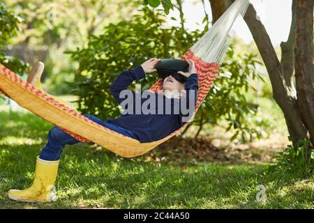 Girl in casual wearing VR glasses and experiencing virtual reali Stock ...