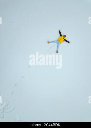 overhead view woman making snow angel Stock Photo - Alamy
