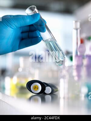 Cropped hand of male scientist mixing chemical formula in test tube at ...