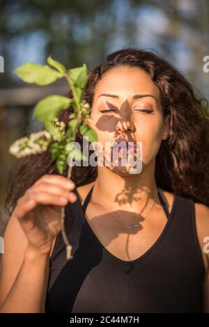 Young hispanic woman holding germany flag and passport smiling and ...