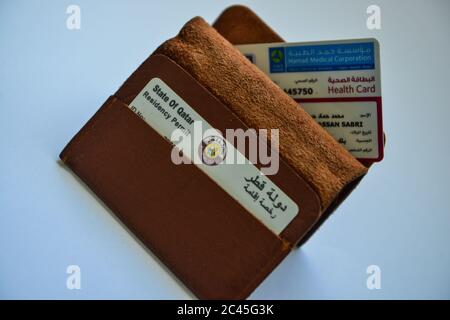 Qatar ID card & Medical Card in Brown Valet on white background Stock ...