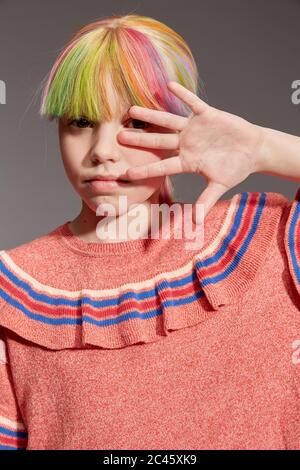Studio shot of a beautiful girl teenager posing over a pink background ...