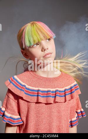 Studio shot of a beautiful girl teenager posing over a pink background ...