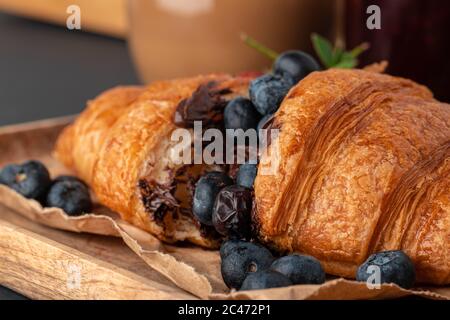 Half cut croissant decorated with fresh berries on wooden table Stock ...