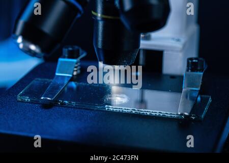 Microscope with lenses close up against dark background Stock Photo - Alamy