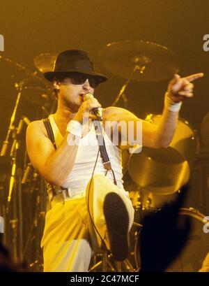 Genesis lead singer, Phil Collins sings the opening song of their ...