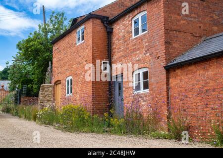 Red brick cottages and flowers. Upper Brailes, Warwickshire, England ...