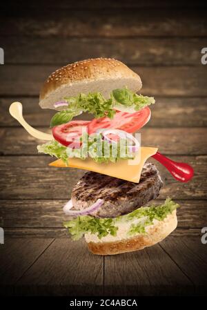 Burger explosion with salad and sauce Stock Photo - Alamy