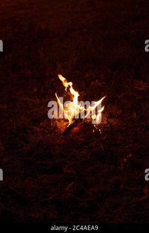 Small campfire on the middle of the field Stock Photo - Alamy
