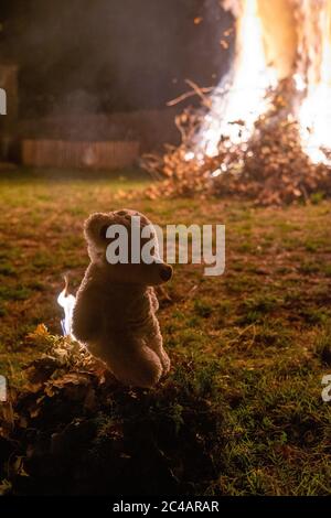 Teddy bear burning in front of a giant bonfire Stock Photo - Alamy