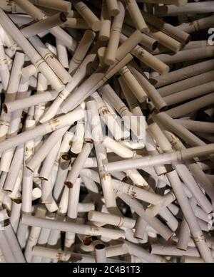Many loose cigarettes background Stock Photo - Alamy