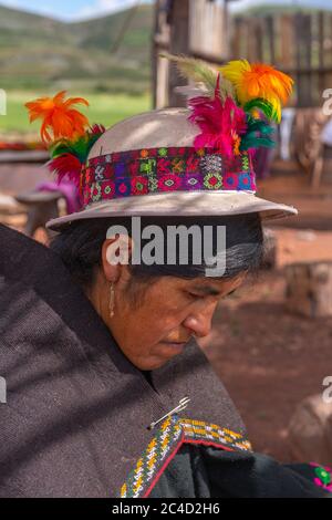 Bolivian indigenous Jalq'a woman weaving a textile with her daughter ...