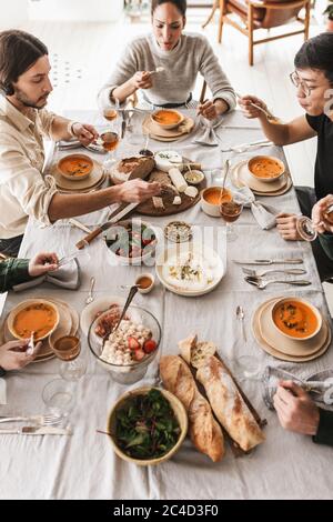 Young afro american woman eating chocolate bar over isolated background ...