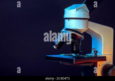 Microscope with lenses close up against dark background Stock Photo - Alamy