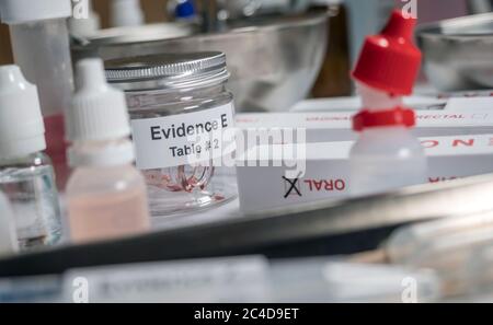 Blood-stained glass sample in an evidence jar, concept image Stock ...