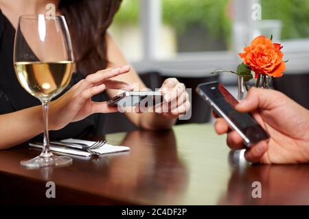 People busy with their phones in a cafe Stock Photo - Alamy