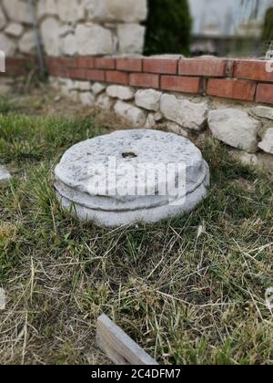 Round granite stone in the sand on the beach Stock Photo - Alamy