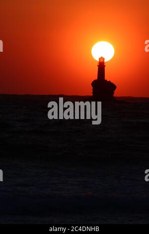 Sunrise at the lighthouse of Tourlitis at Andros, Greece Stock Photo ...