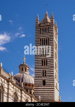 Striped bell tower of Siena Cathedral and curving facades of its ...